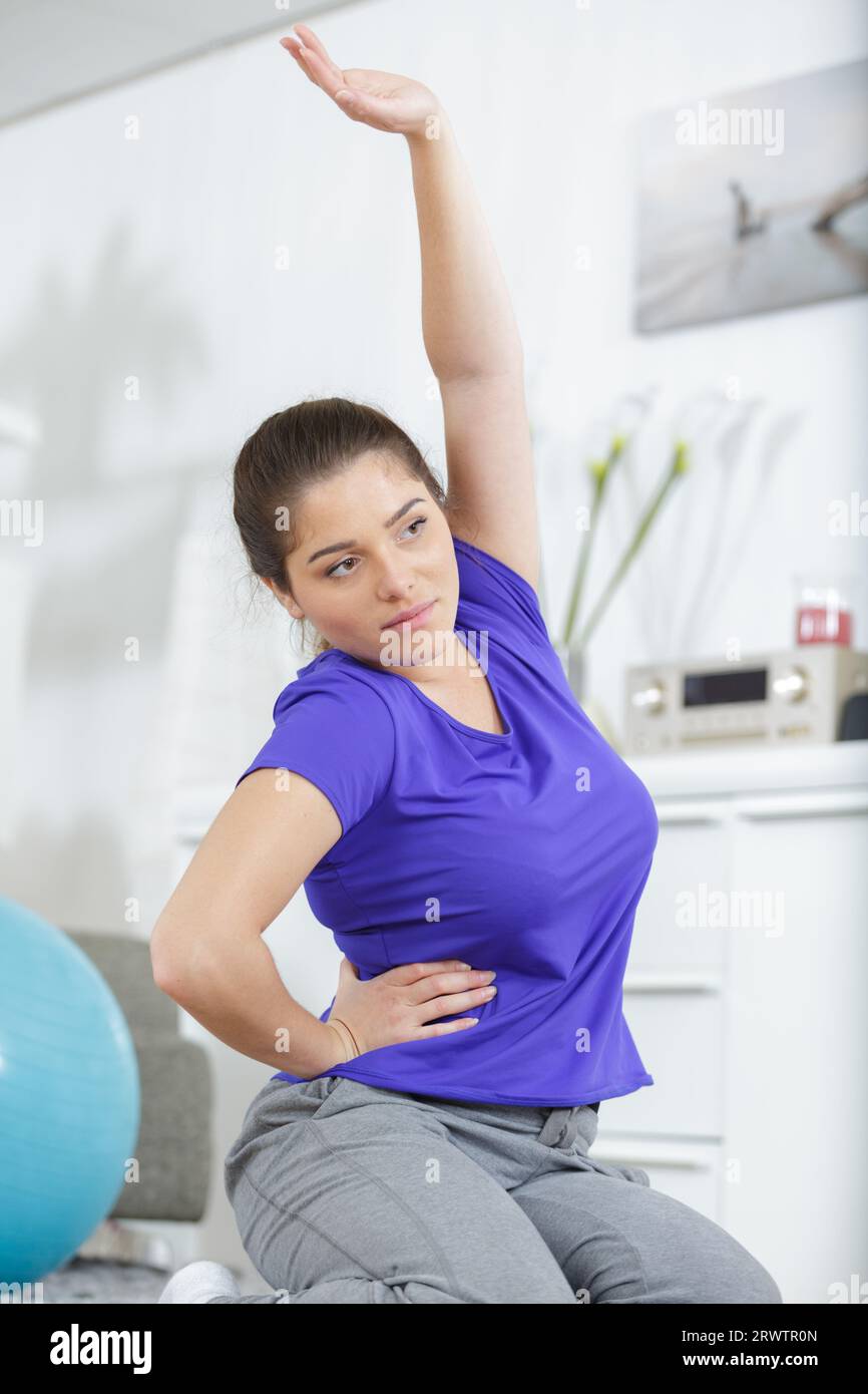 woman on yoga mat stretching arm above her head Stock Photo - Alamy