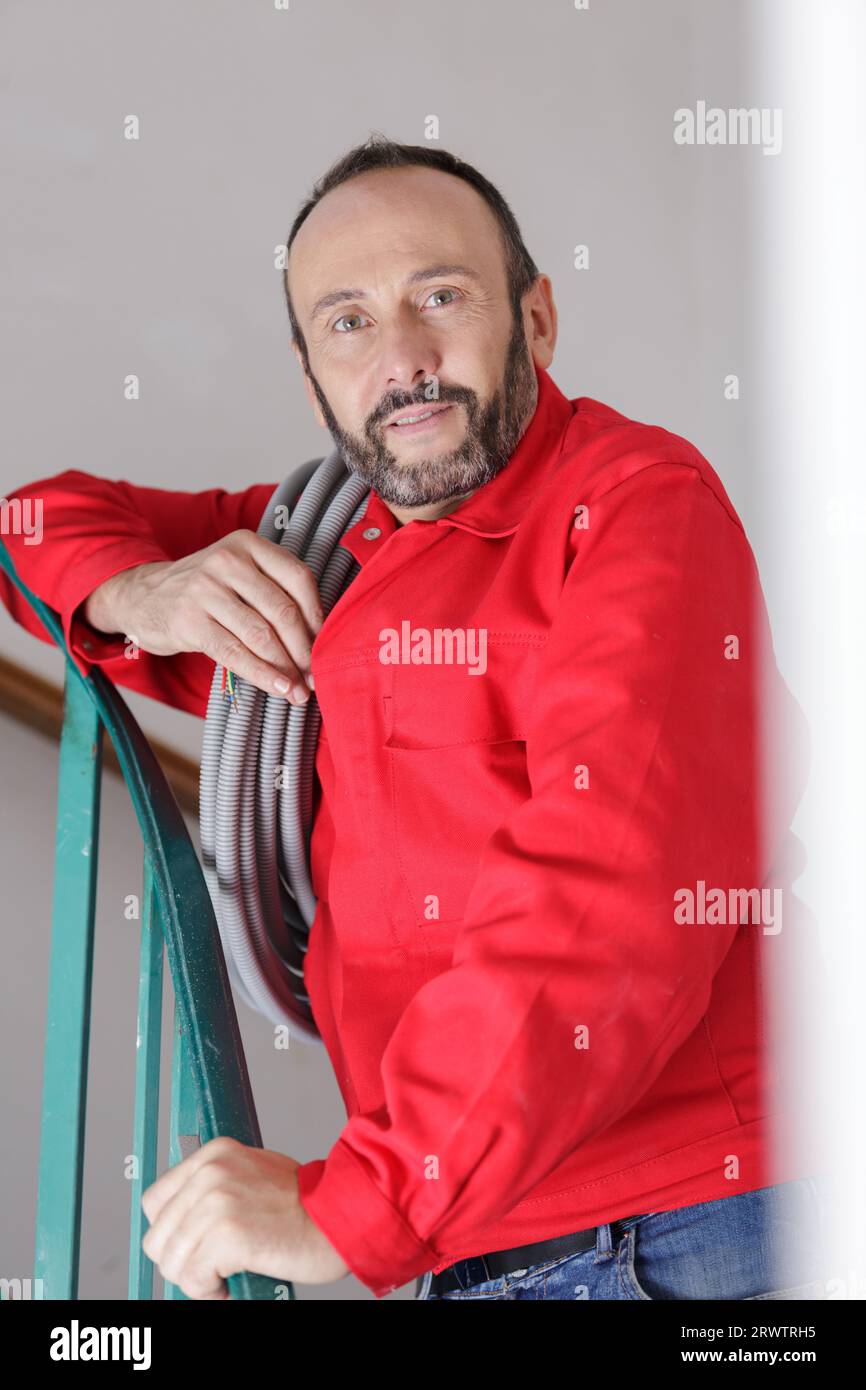 handsome man electrician with wiring cable Stock Photo - Alamy