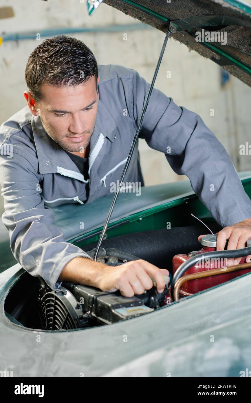 a mechanic working on engine Stock Photo - Alamy
