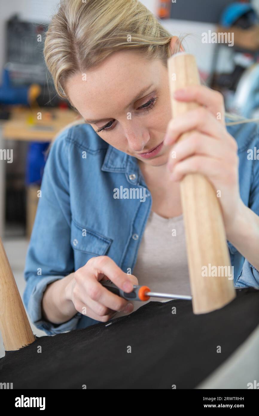 Young woman repairing chair at home hi-res stock photography and images ...