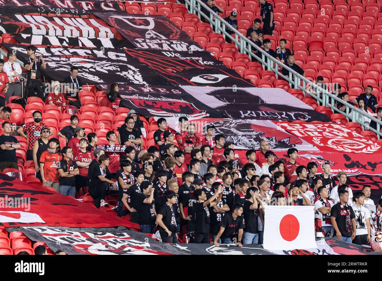 Wuhan, China. 20th Sep, 2023. Fans of Urawa Red Diamonds cheer during ...
