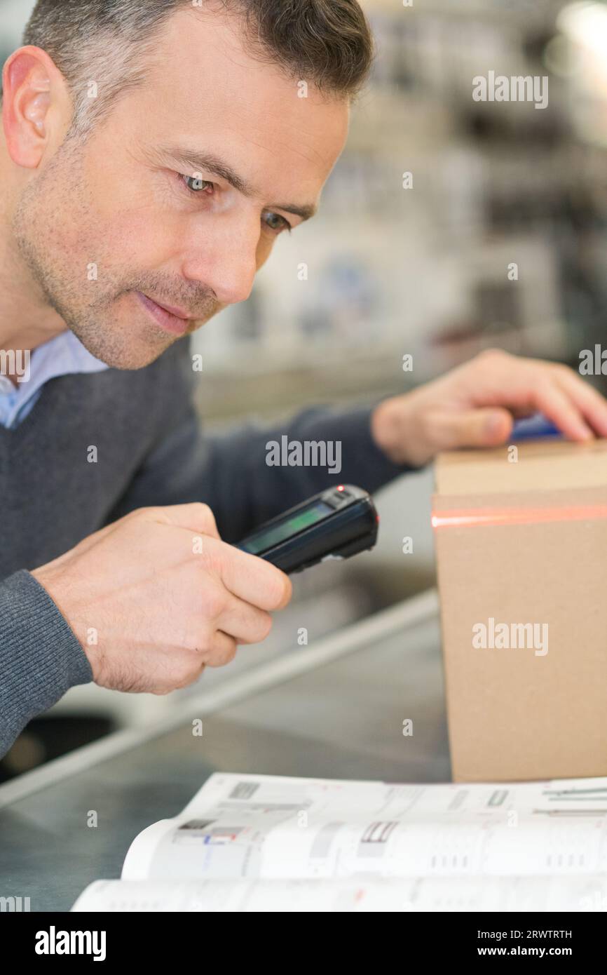 warehouse worker scanning box Stock Photo - Alamy