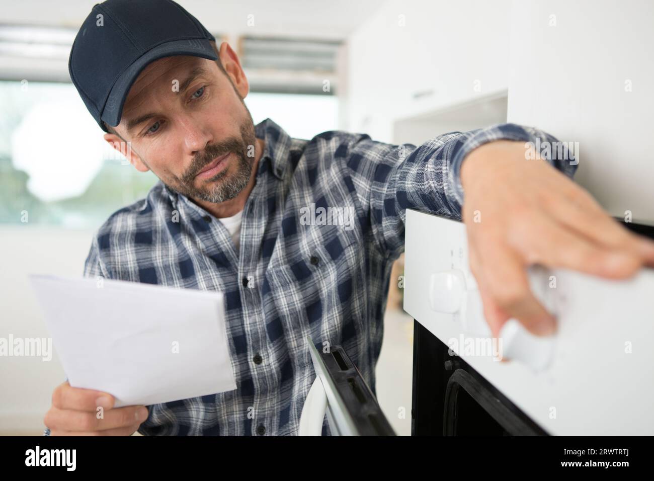 concentrated contractor reading instructions for oven Stock Photo - Alamy