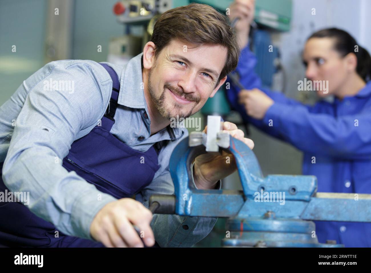 metalworker tightening clamp in an engineering workshop Stock Photo - Alamy