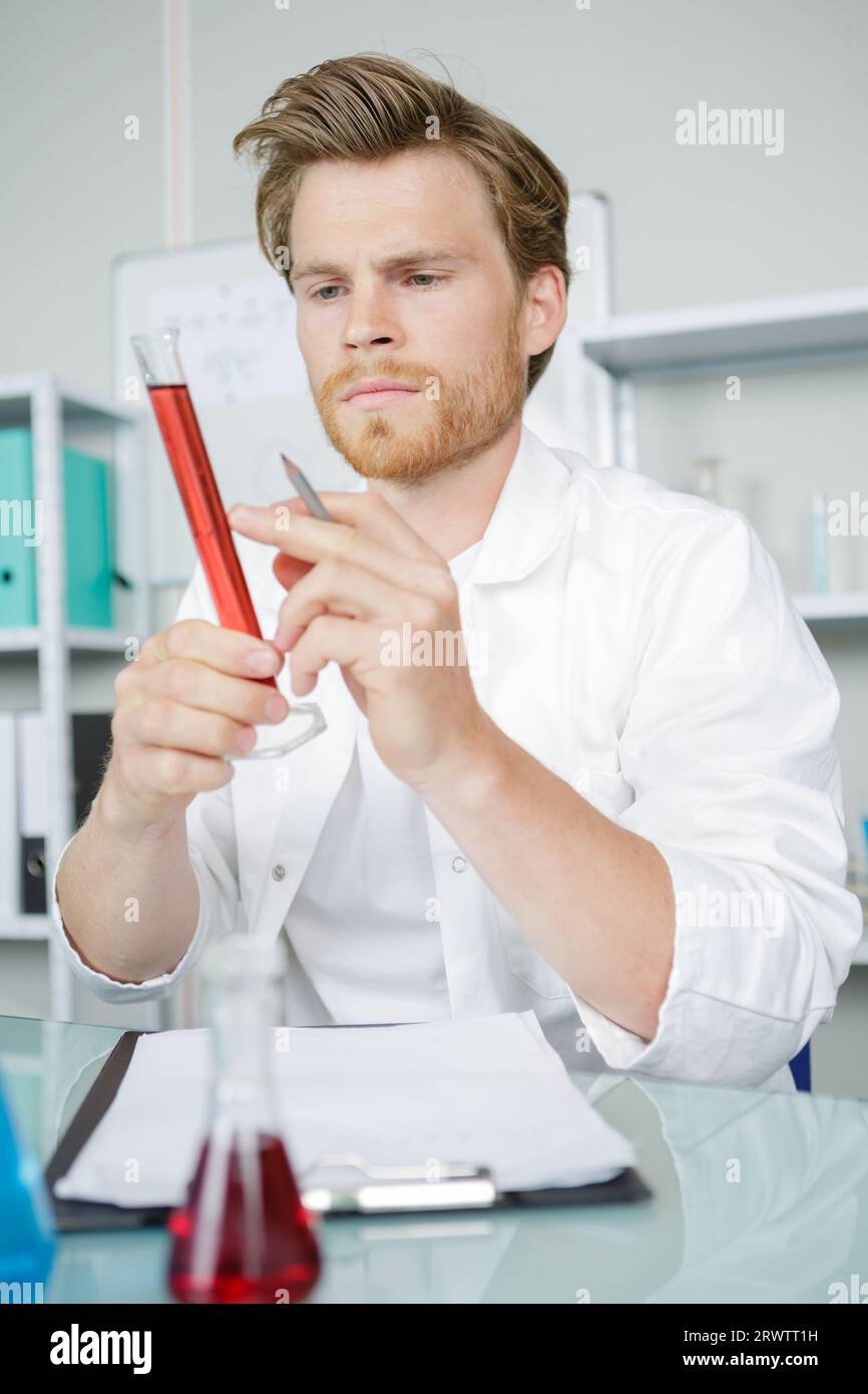 male chemist analyzes blood in a lab Stock Photo - Alamy