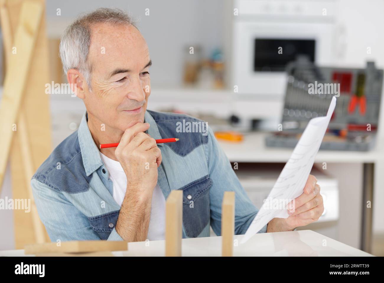 a senior man reading instruction Stock Photo - Alamy