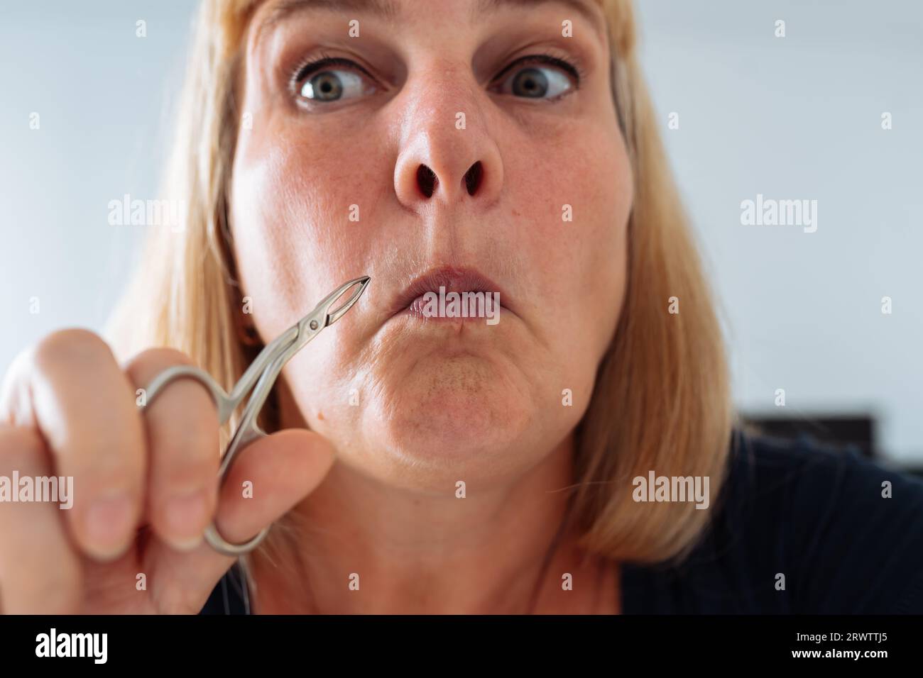 Woman plucking facial hair hi-res stock photography and images - Alamy