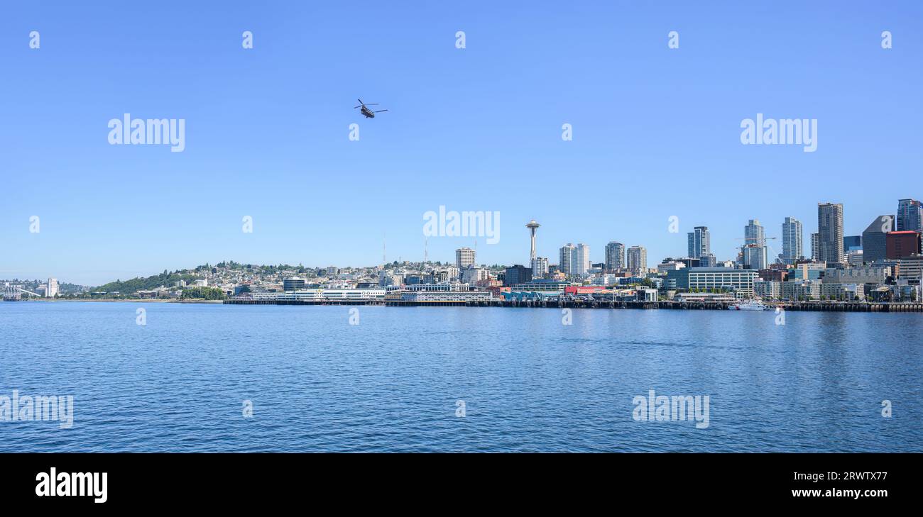 A helicopter flying across Elliott Bay in front of the Seattle skyline ...