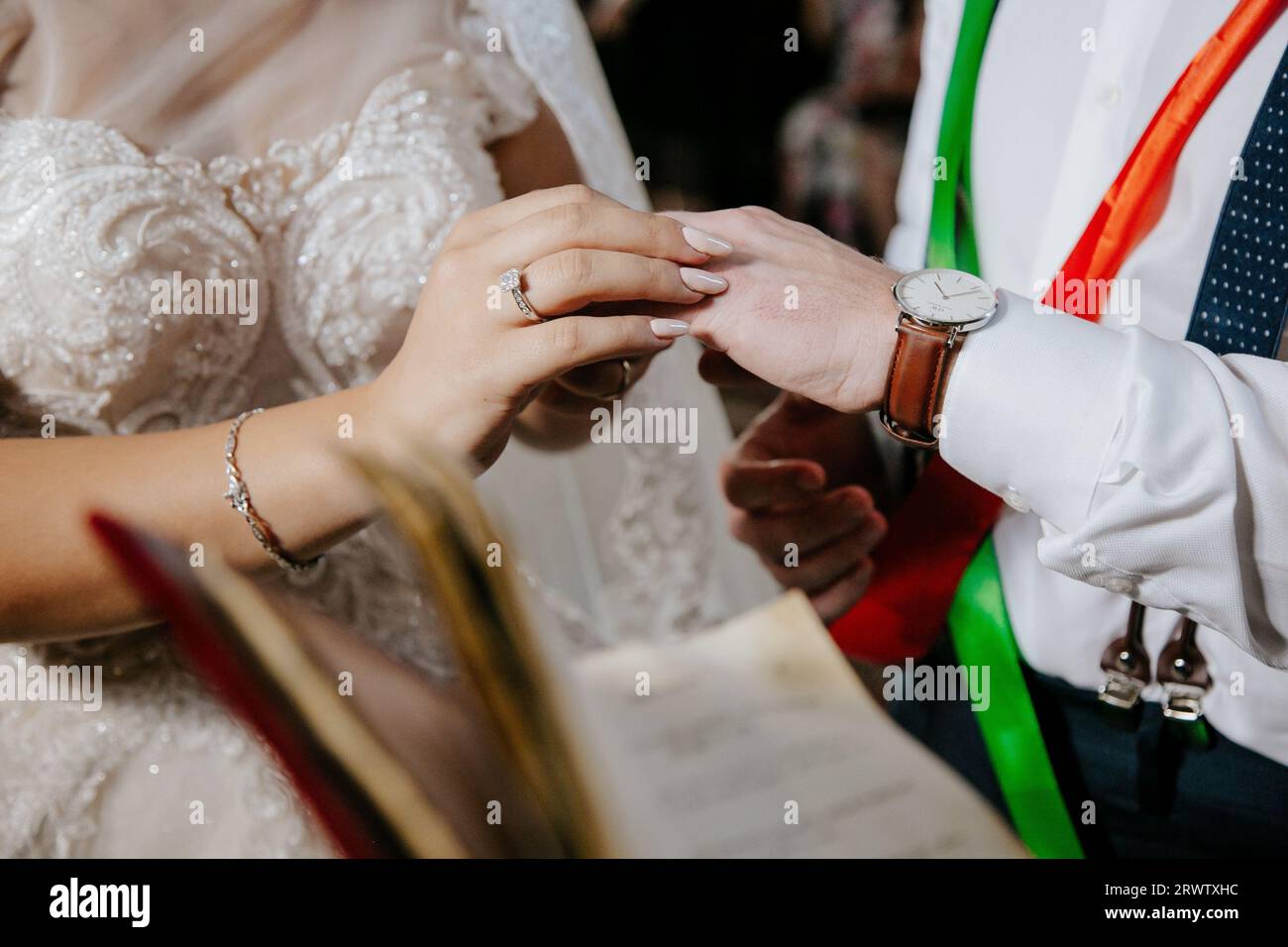 A bride and groom wearing wedding rings on each other in a church Stock ...