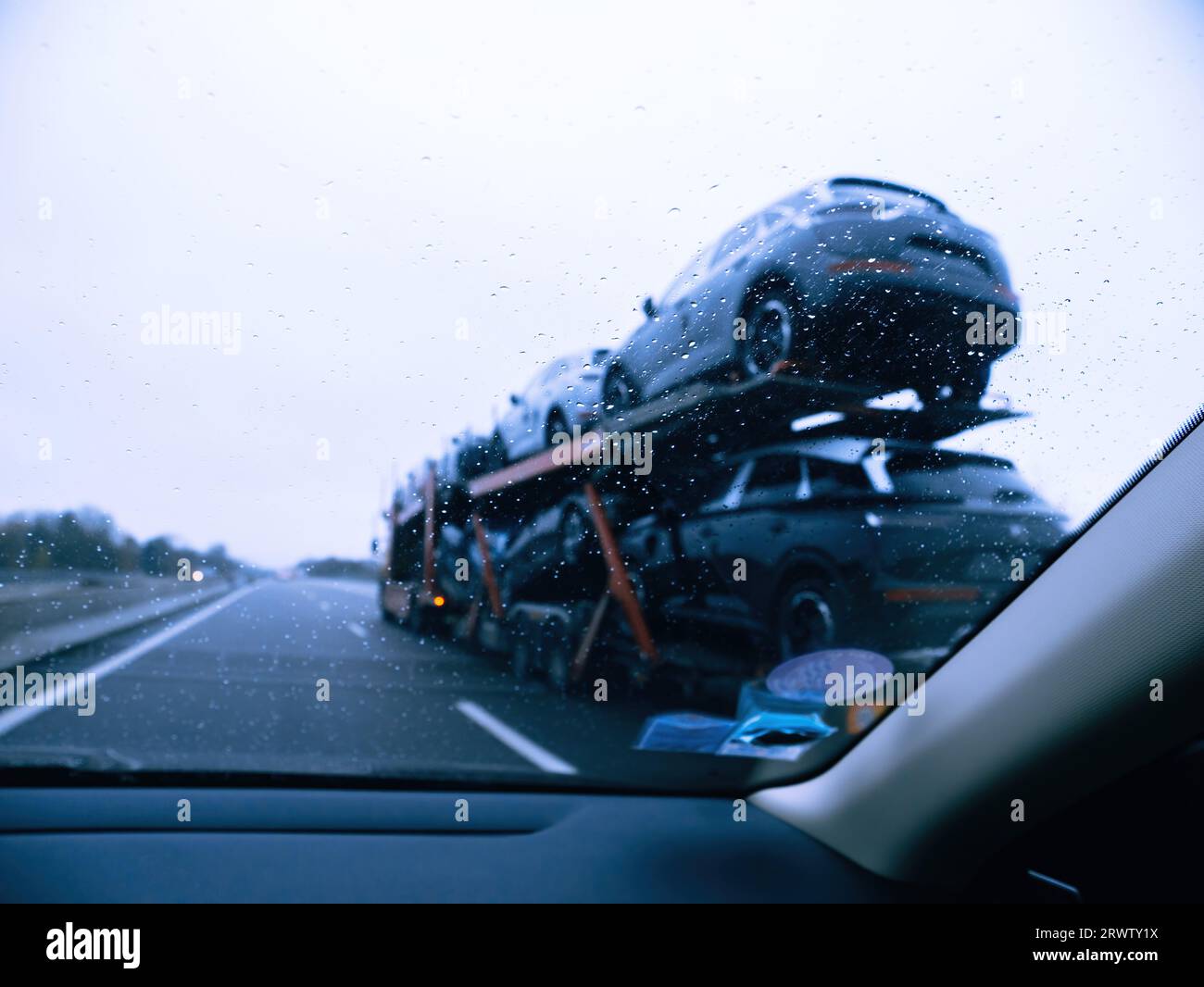 Inside view from a car with a windshield covered in water drops ...