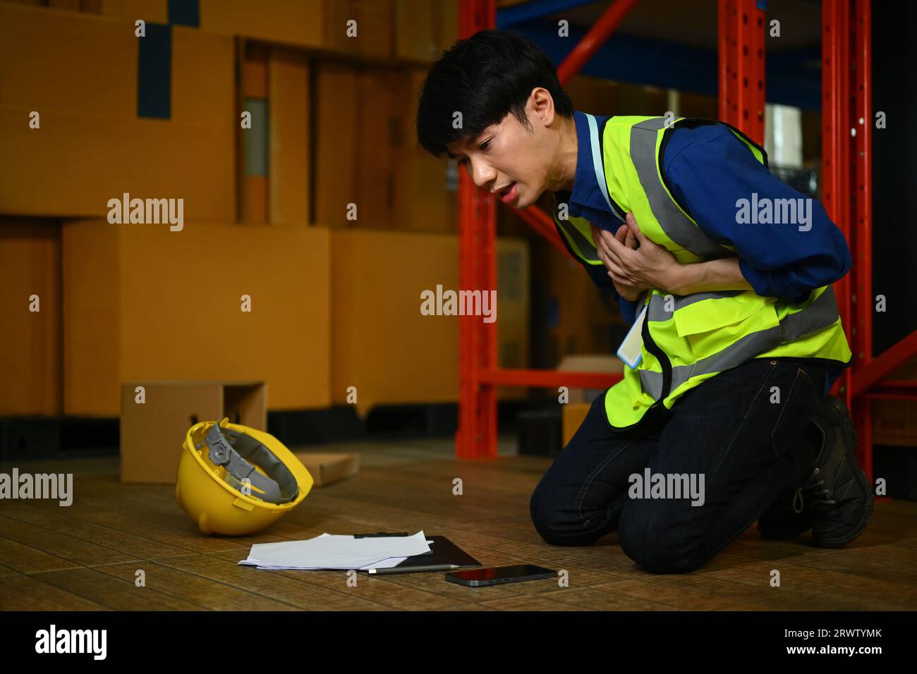 Male worker suffering from chest pain, shortness of breath sitting on ...