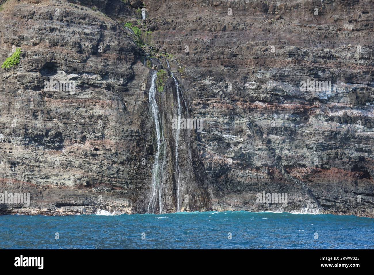 A scenic view of a waterfall cascading down a rocky cliffside Stock ...
