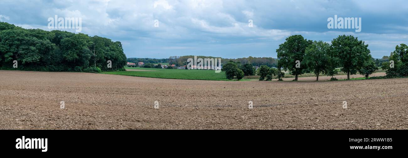 Extra large panoramic view over plowed soil of agriculture fields ...