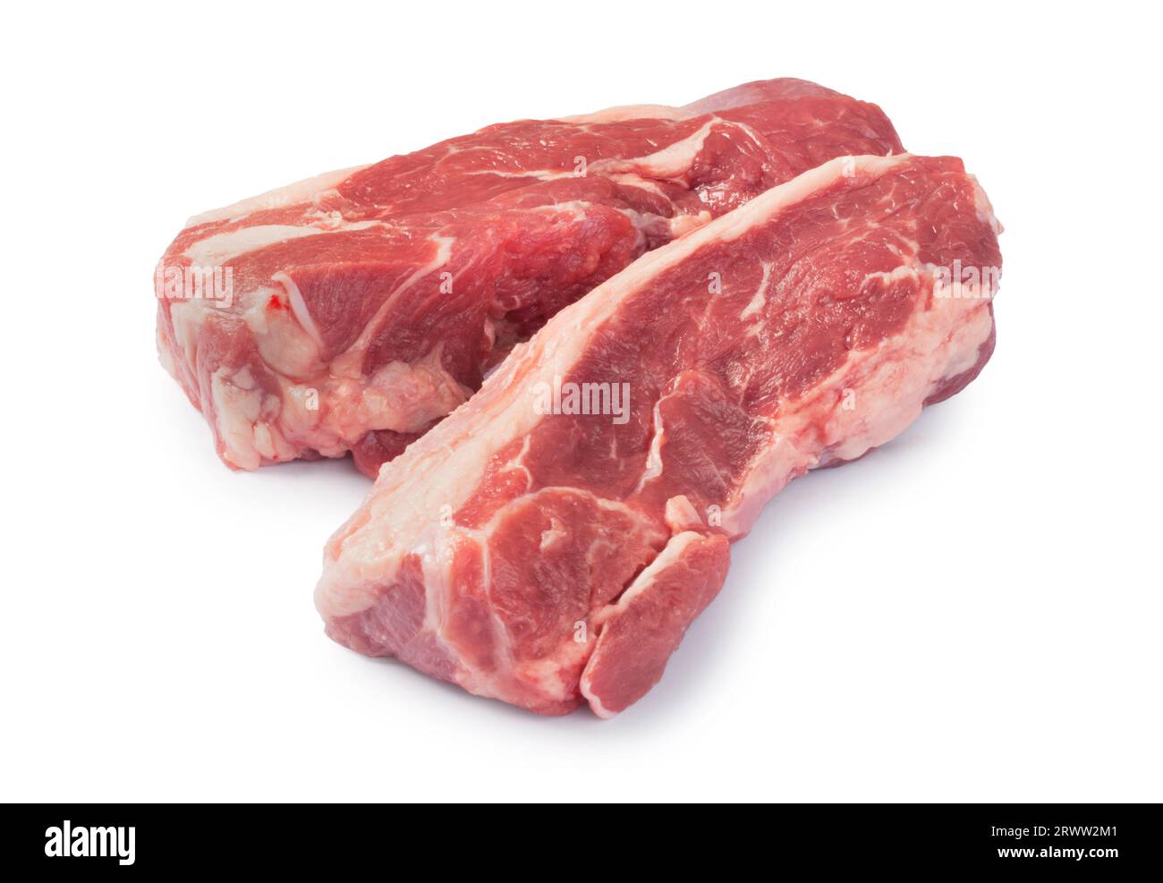 Studio shot of raw rump of lamb steaks cut out against a white ...