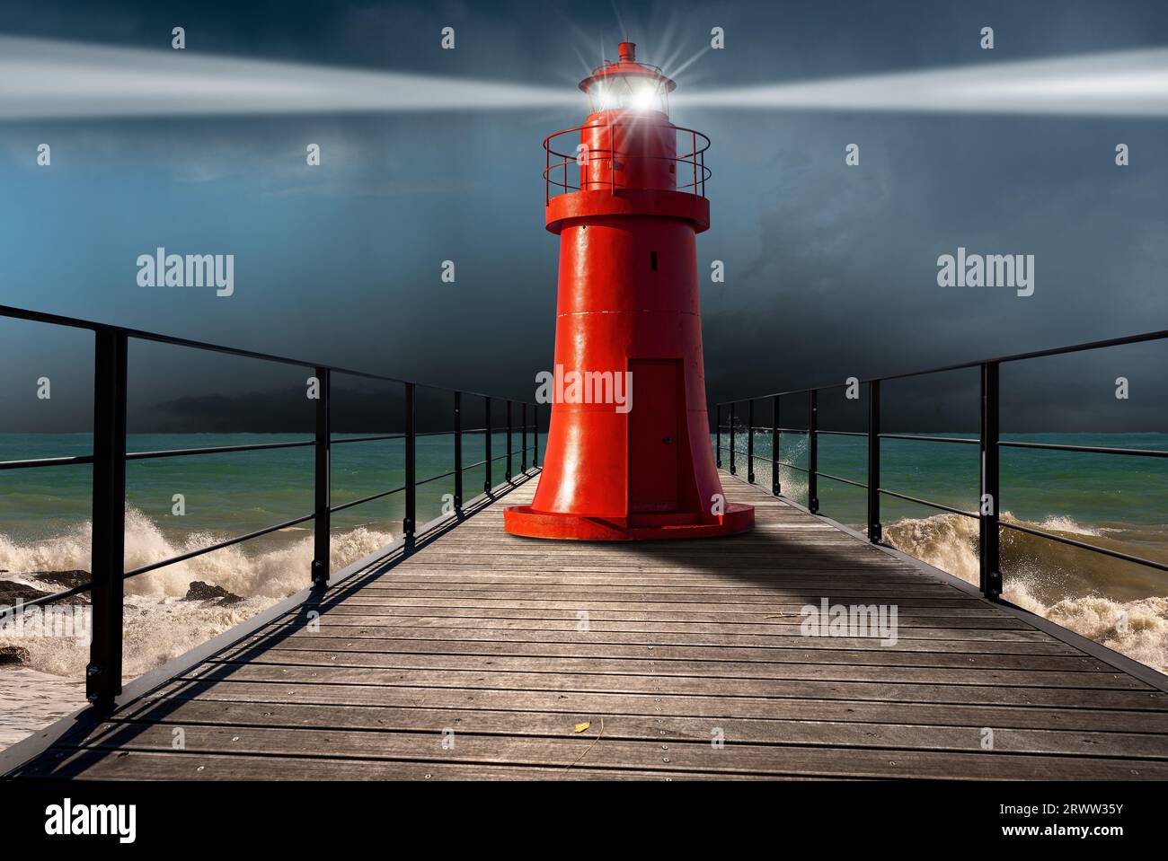 Old red lighthouse with light beams on a wooden pier with rough sea ...