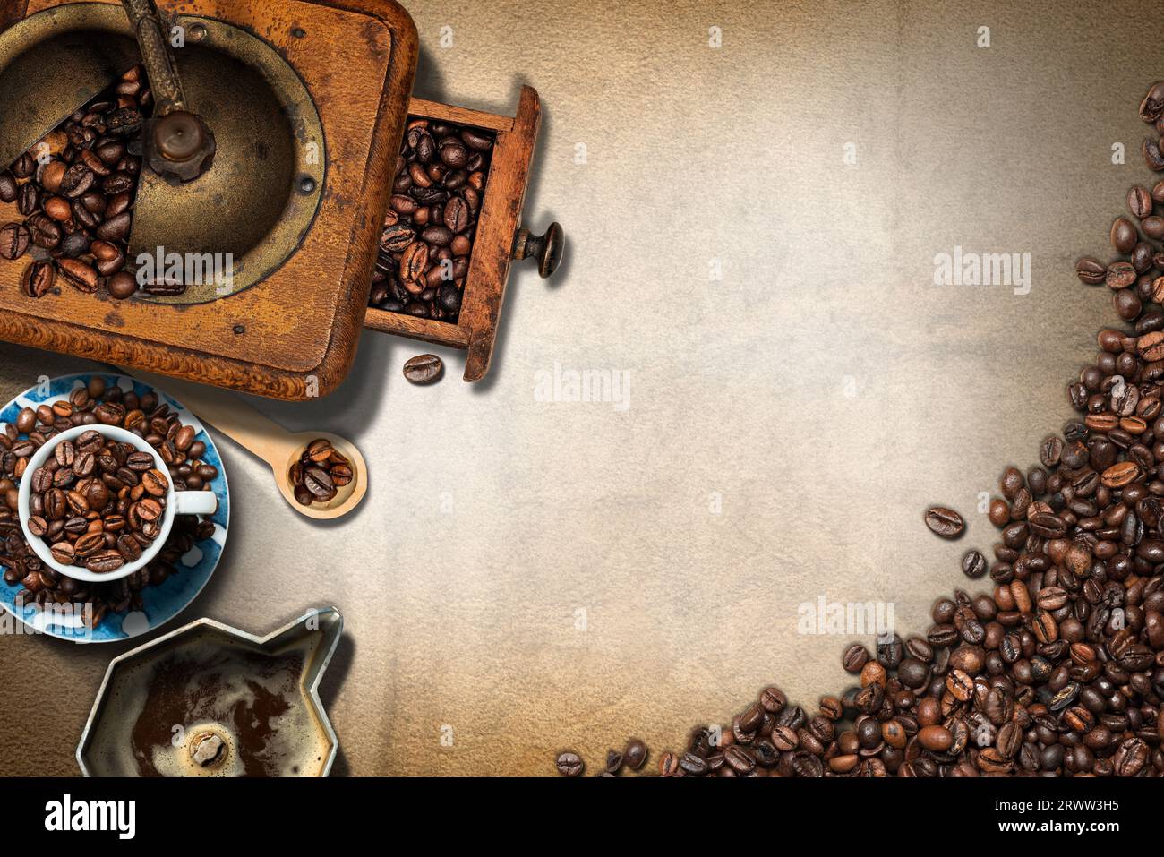 Old manual coffee grinder, cup full of roasted coffee beans and an ...