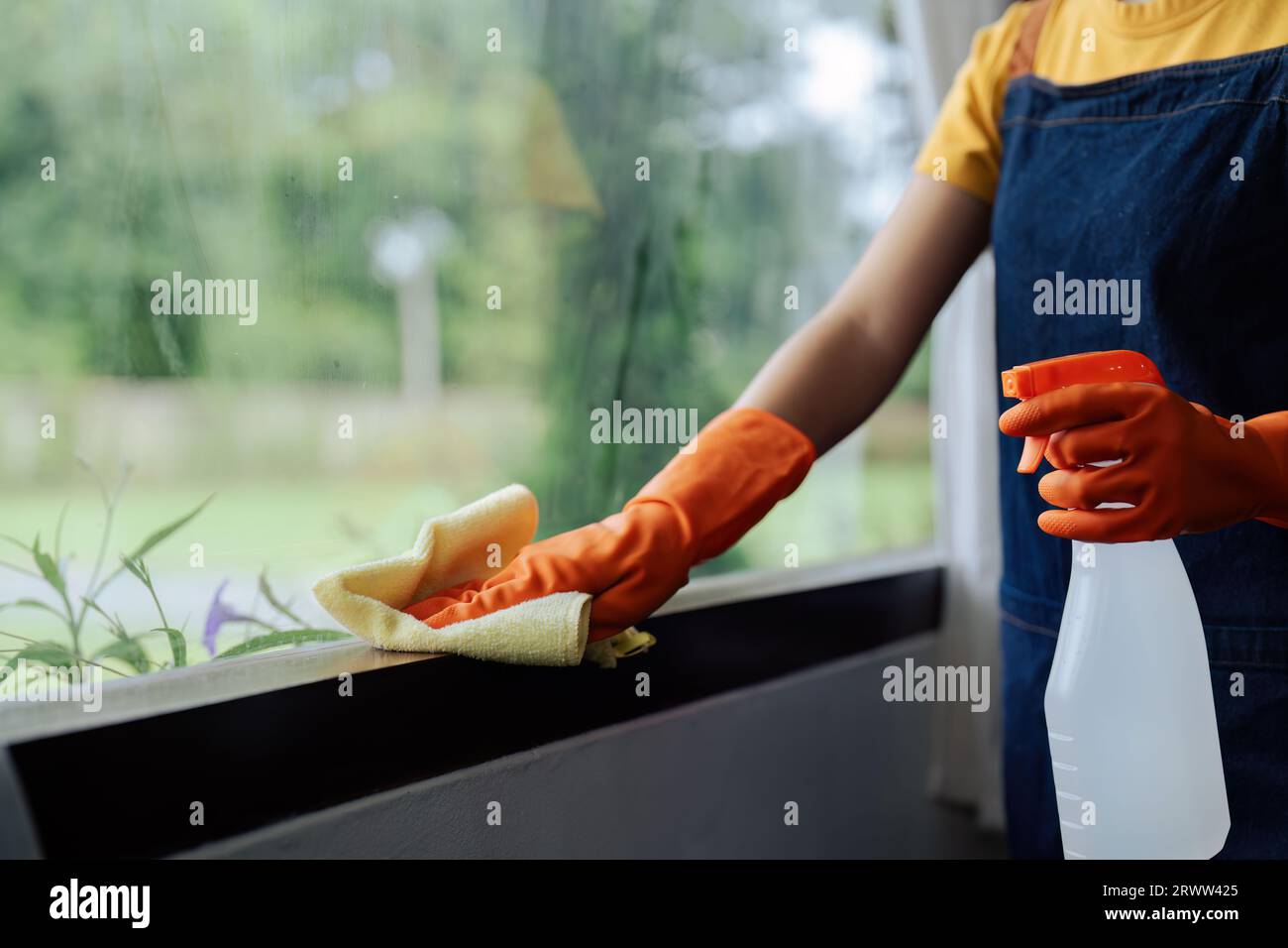 Woman wiping the edge window with microfiber cloth. Close-up detail ...