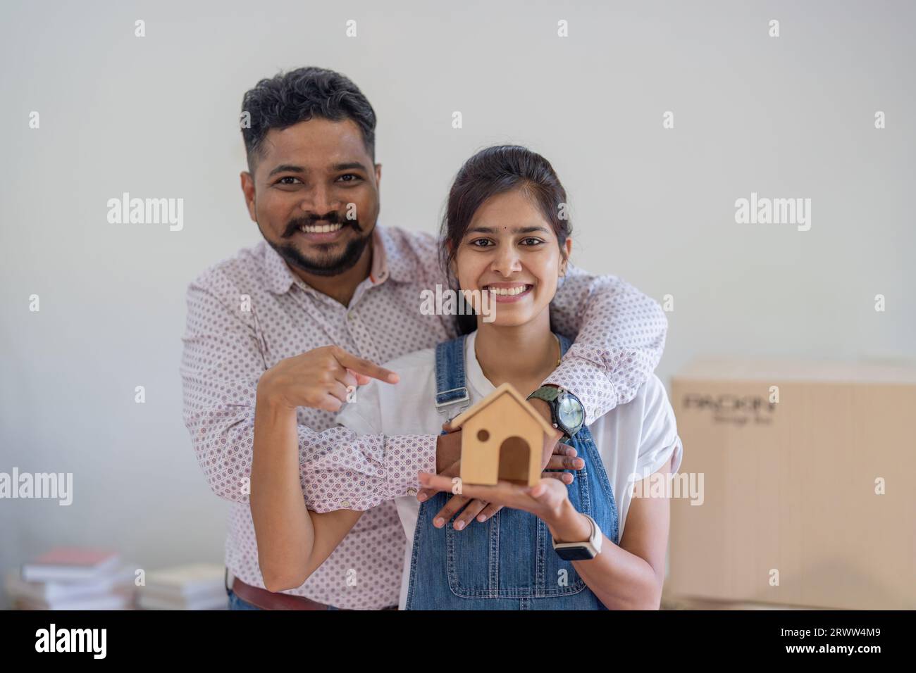 Indian couple is holding for a model home to choose a new home. relocation concept Stock Photo ...