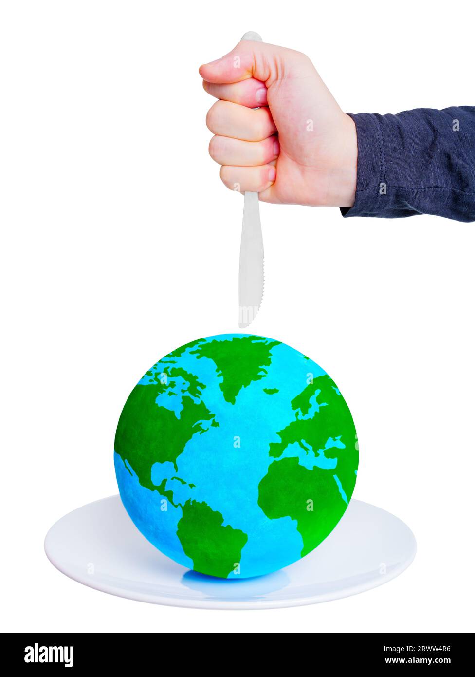 Hand trying to stab a blue and green globe placed on a white plated ...
