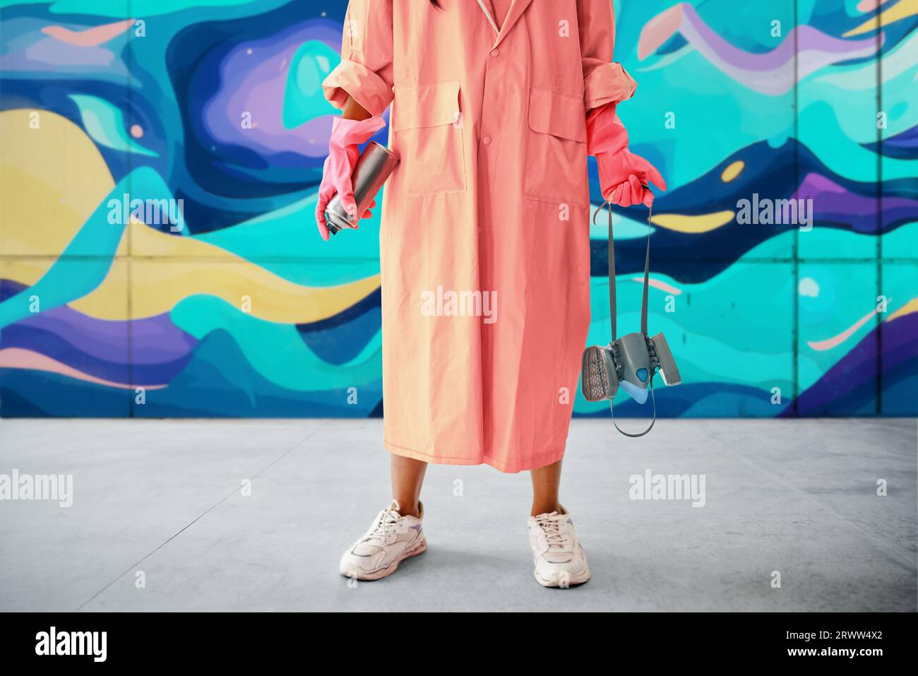 Cropped image of street artist with spray paint can and respirator mask ...