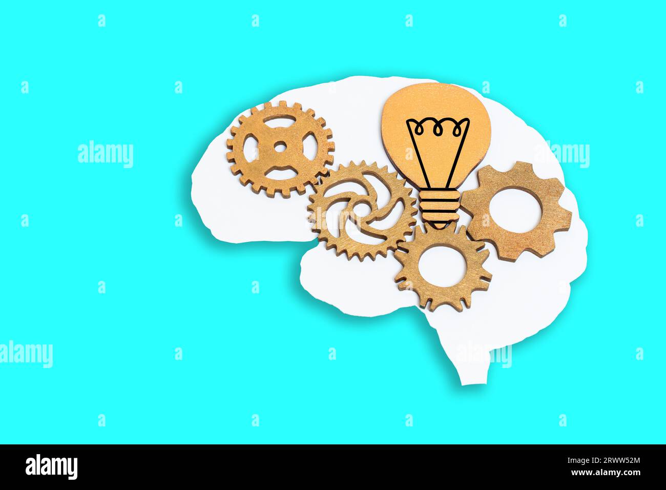Flat brain shape adorned with wooden gears and a light bulb ...