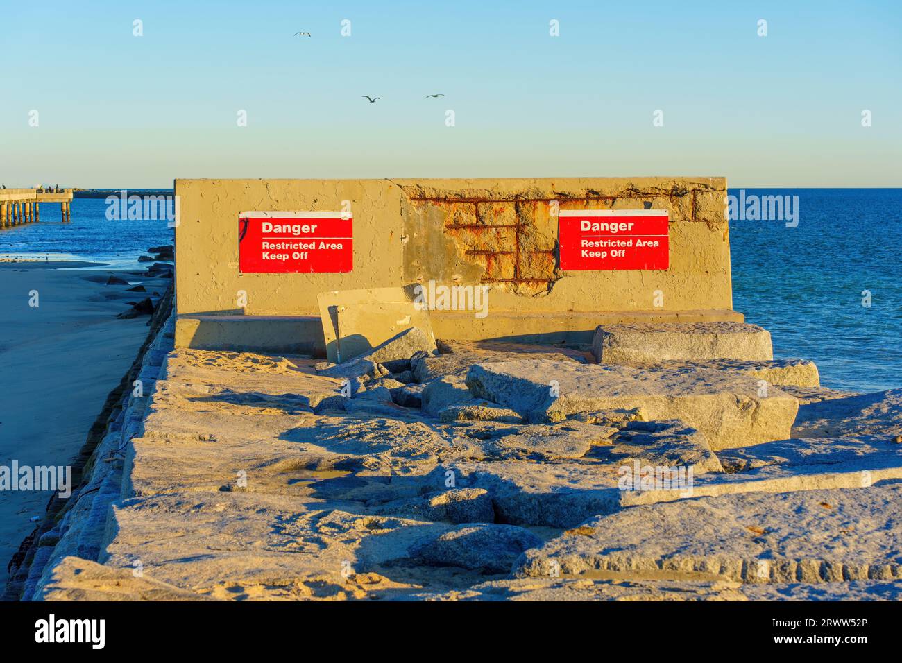 Danger and Restricted area warning signs placed at the breakwater near ...