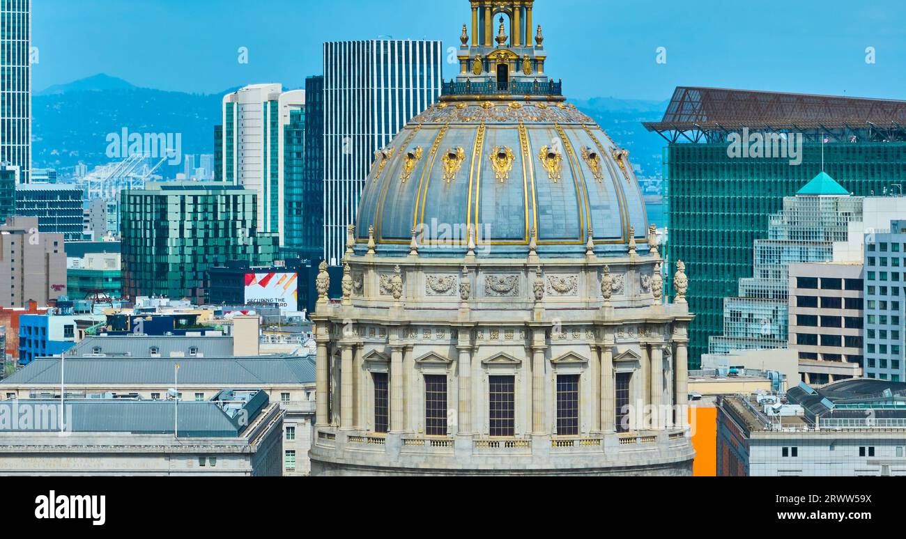 Aerial zoomed in view of city hall dome roof with skyscraper buildings ...