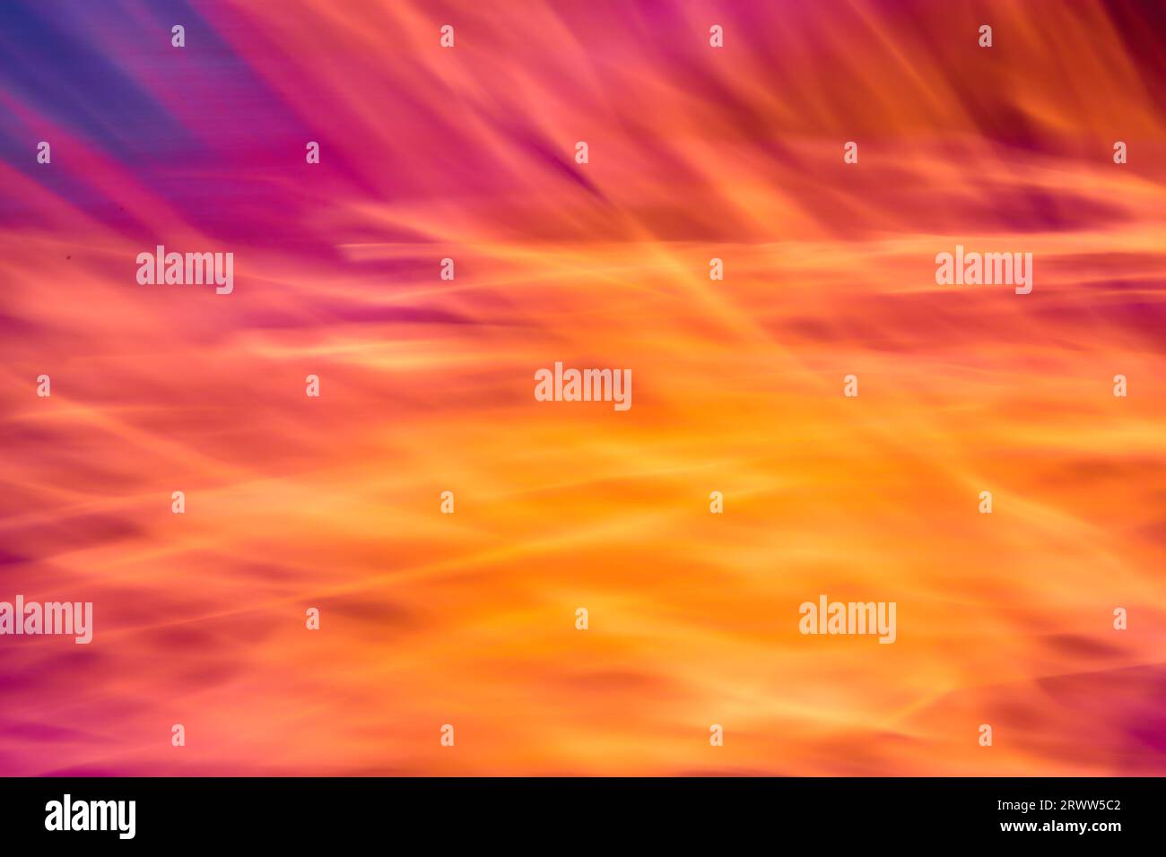Abstract bright orange and yellow flames with pink and purple edges ...