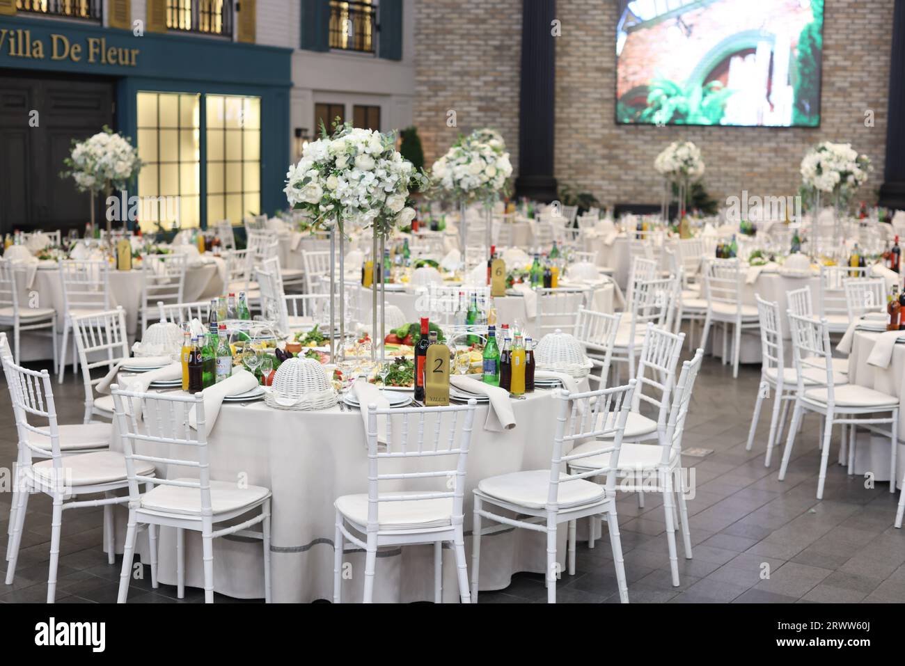 An elegant wedding venue is set up and ready for a celebratory event to ...