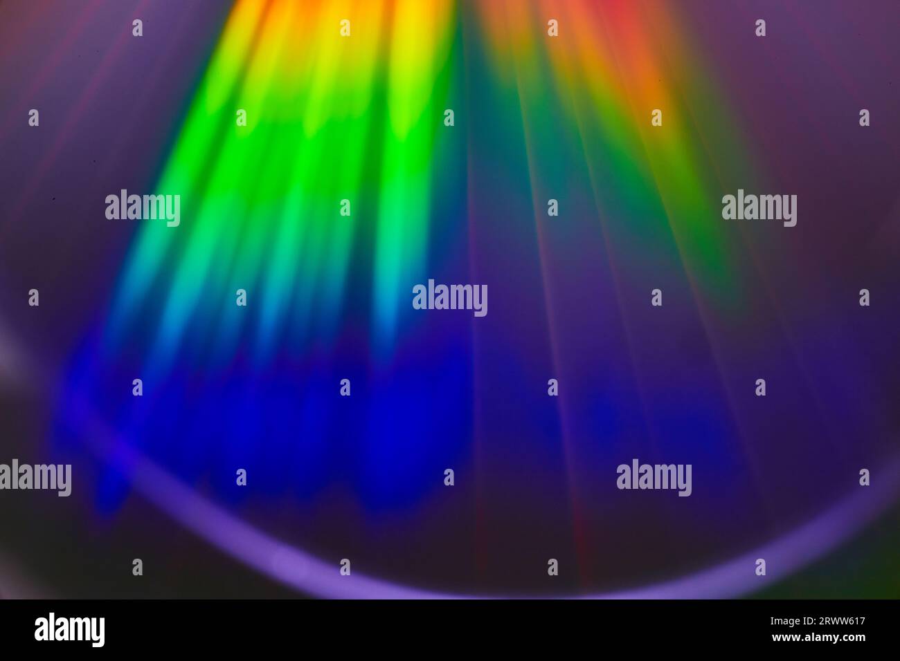 Abstract light beams filtering from surface into deep blue in rainbow ...