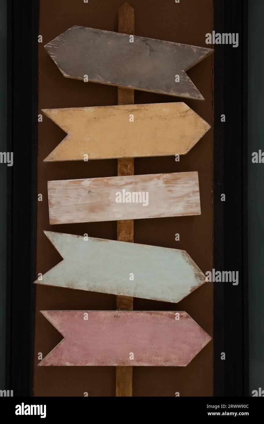 Vintage post with several woods shaped like arrows that indicate in ...