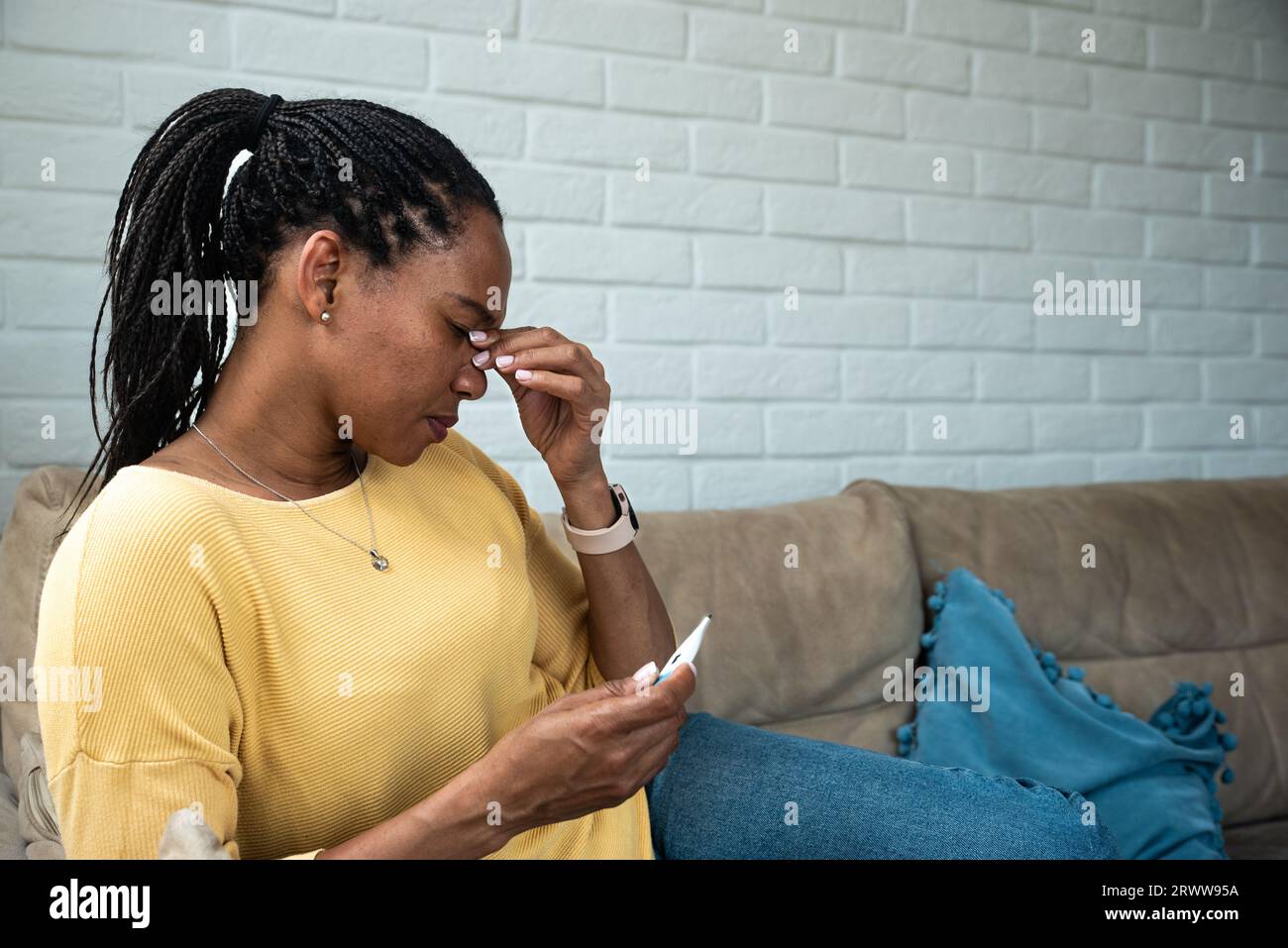Sick woman lying in bed with high fever. African American female ...