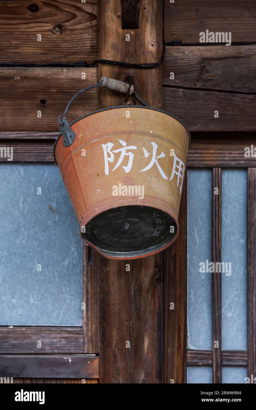 Fire buckets hanging at the entrance of an old house Stock Photo - Alamy