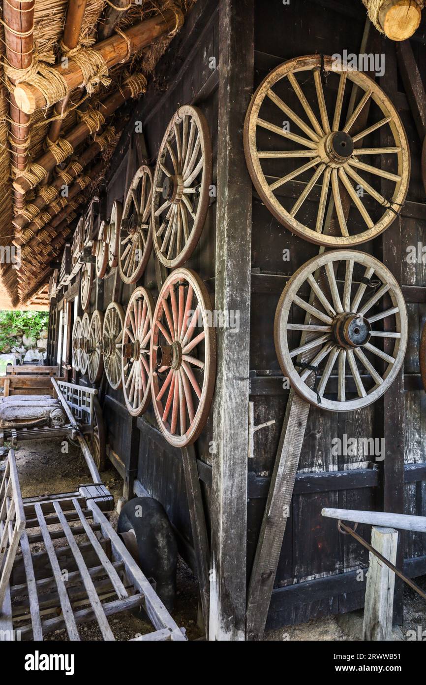 Hida village carts and a view of many wheels displayed on the outside ...