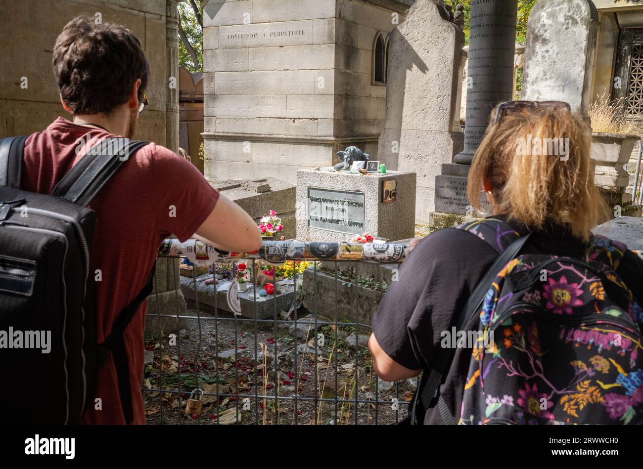 Two tourists visit the grave of Jim Morrison, the singer and frontman ...