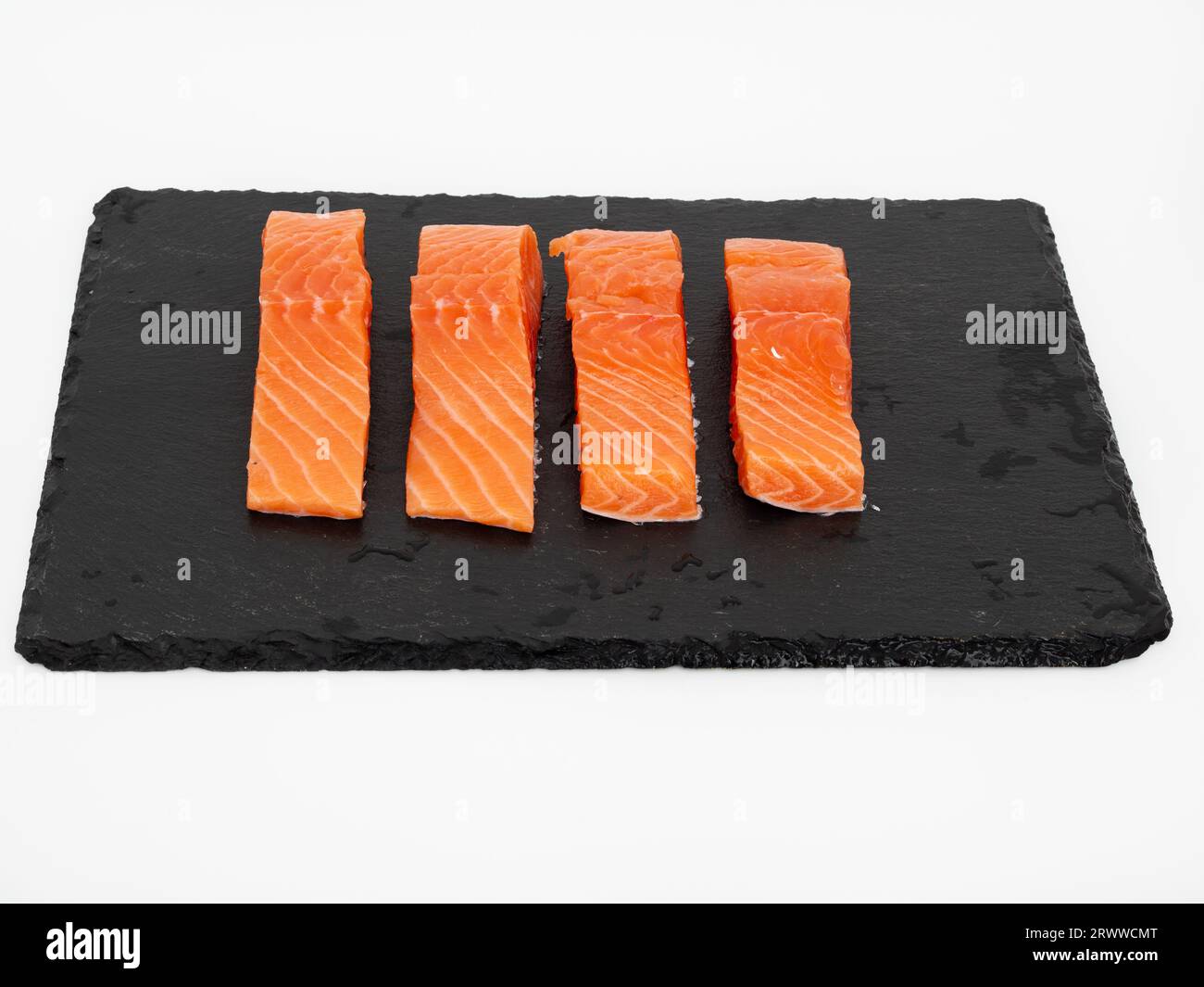 Salmon fish fillet on Slate stone. Red fish fillet close-up on a white ...