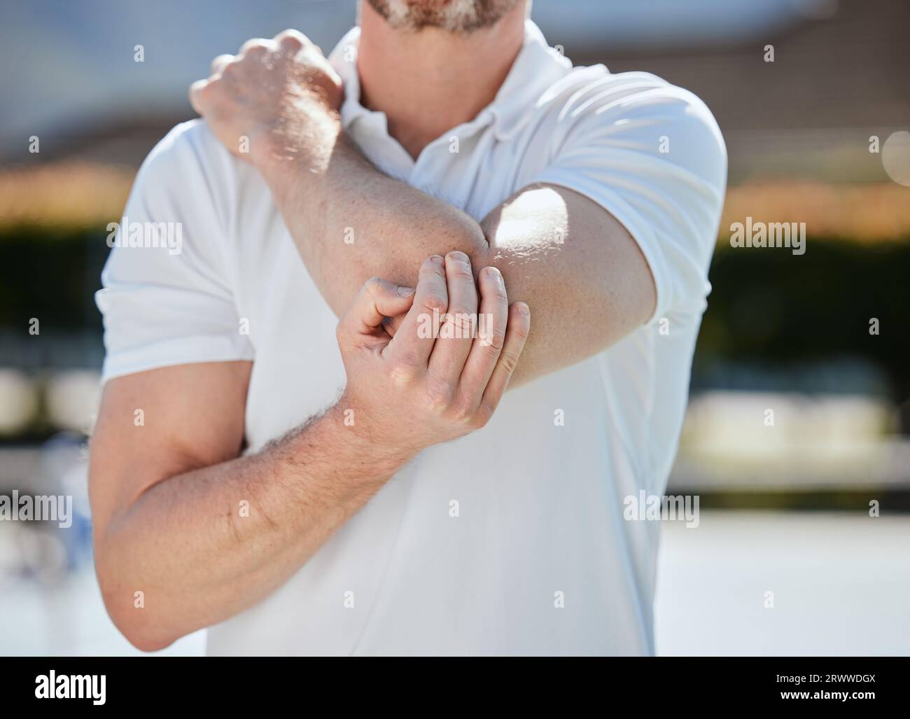 Elbow, pain and person with injury, fitness and athlete outdoor ...