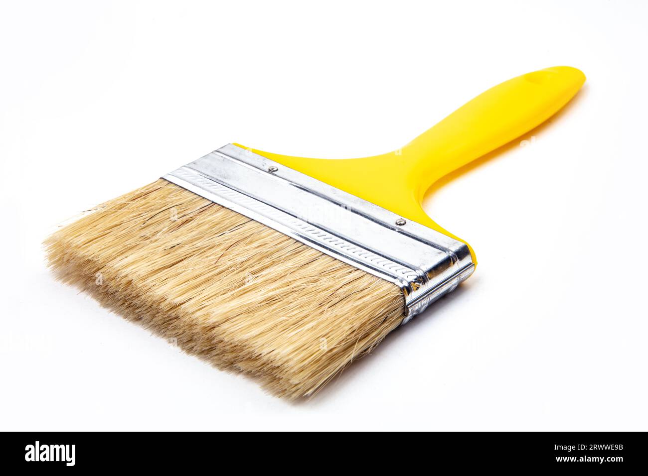 Wide paint brush with yellow handle isolated of white background Stock ...