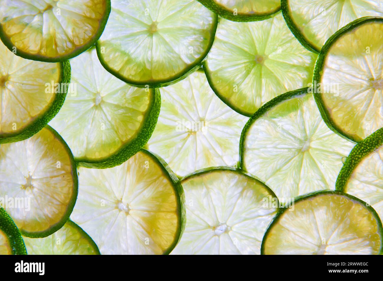 Wall of overlapping green lime slices in background asset of citrus fruit Stock Photo - Alamy
