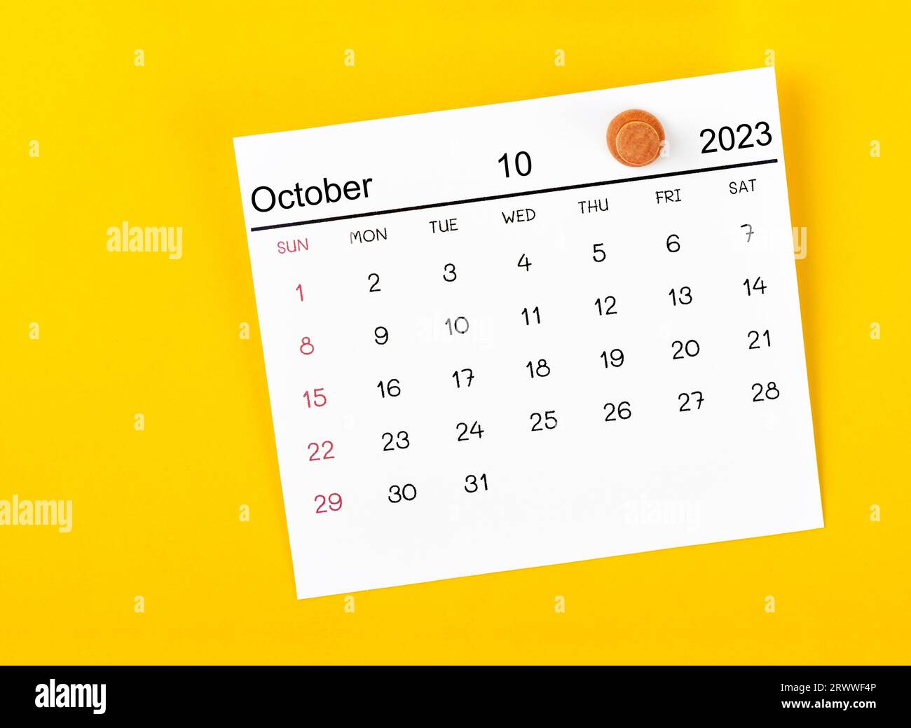 October 2023 and wooden push pin on yellow background Stock Photo - Alamy