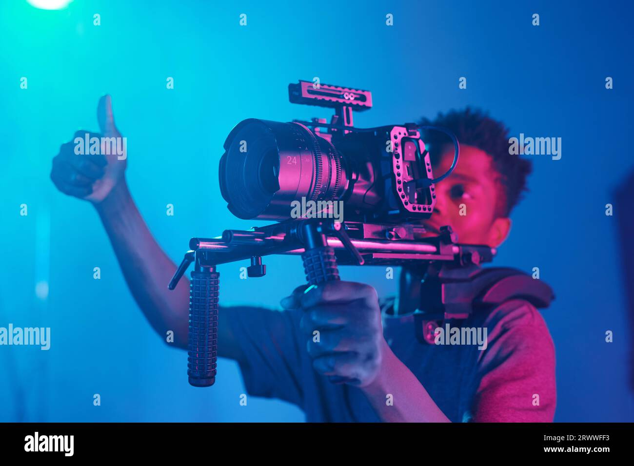 Professional cameraman showing thumb up in process while shooting ...