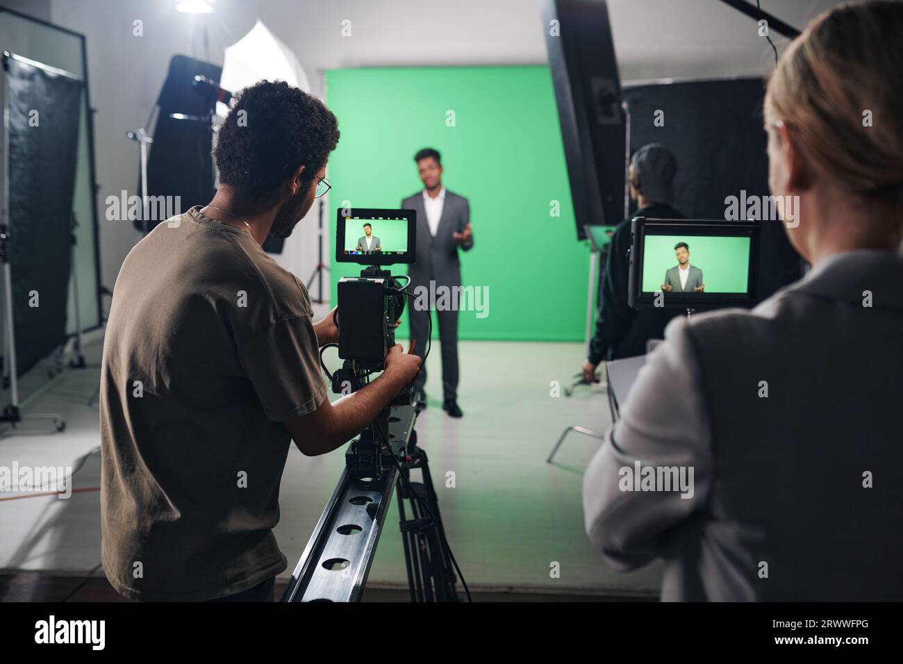 Operator using professional camera to shoot TV program with journalist ...