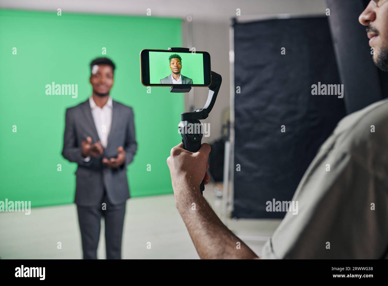 Cameraman shooting th presenter on smartphone while he speaking on ...