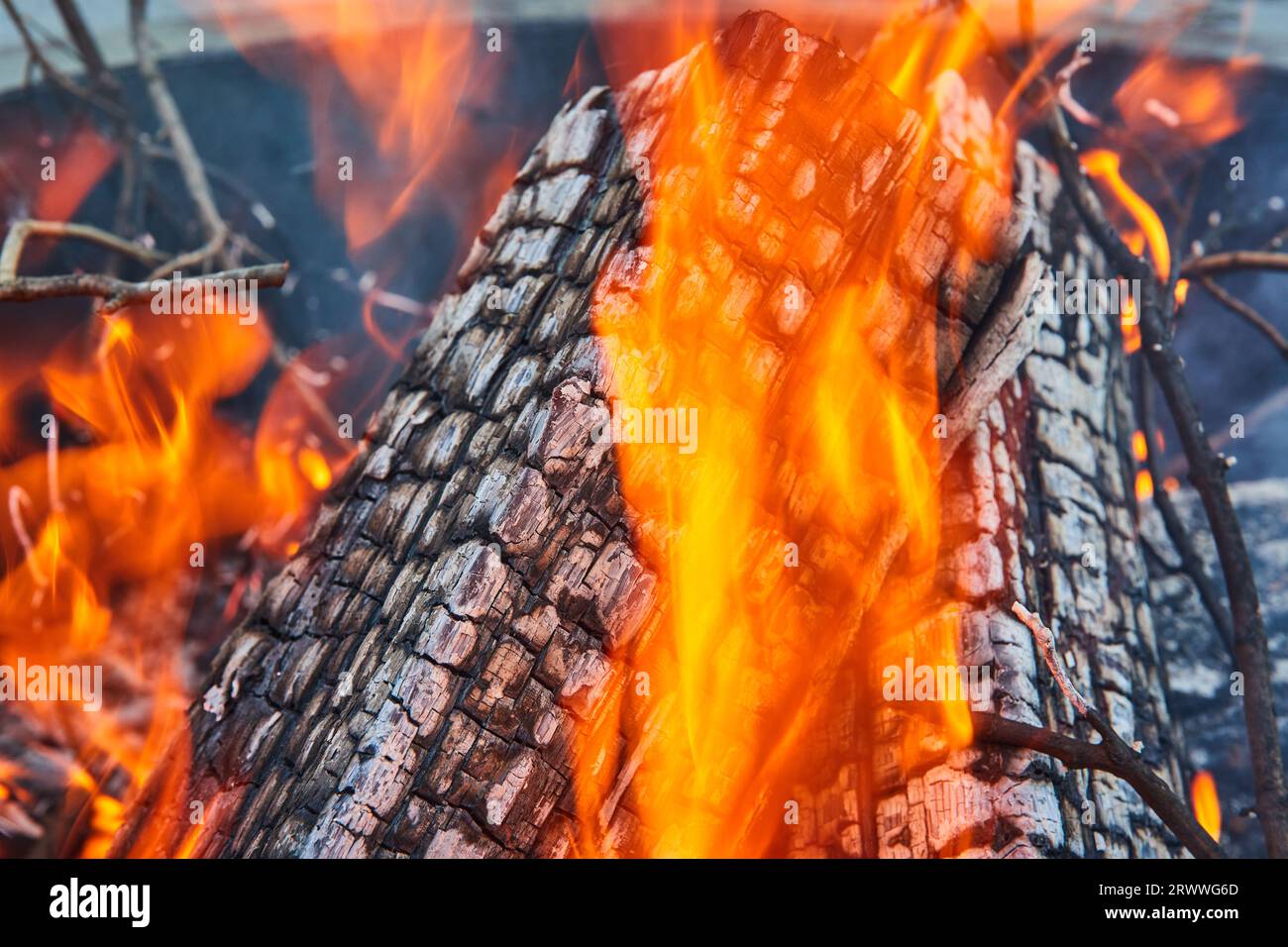 Background asset close up of ashen logs on fire with thick yellow and ...
