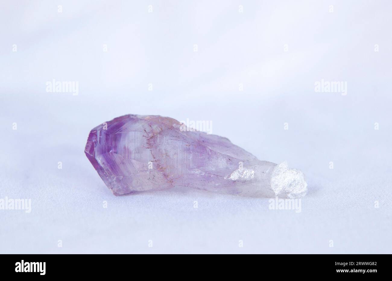 Brazilian amethyst fragment. Isolated over white fabric cloth Stock ...