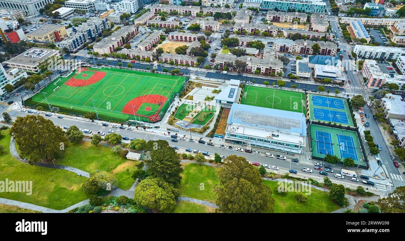 Aerial apartment buildings with multiple sport fields and courts in San ...