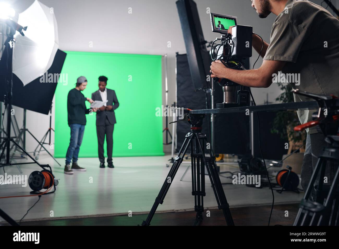 Cameraman shooting TV program on professional camera in studio Stock ...
