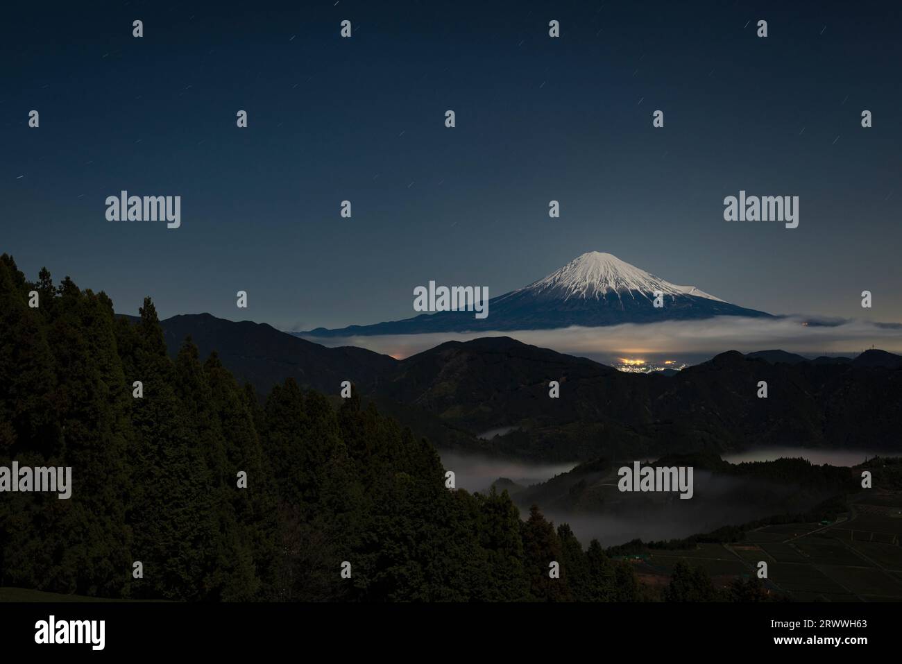 Fuji illuminated by the full moon over the sea of clouds viewed from ...