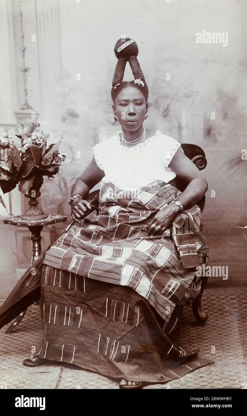 Studio portrait of an African woman with an elaborate hairstyle twisted ...