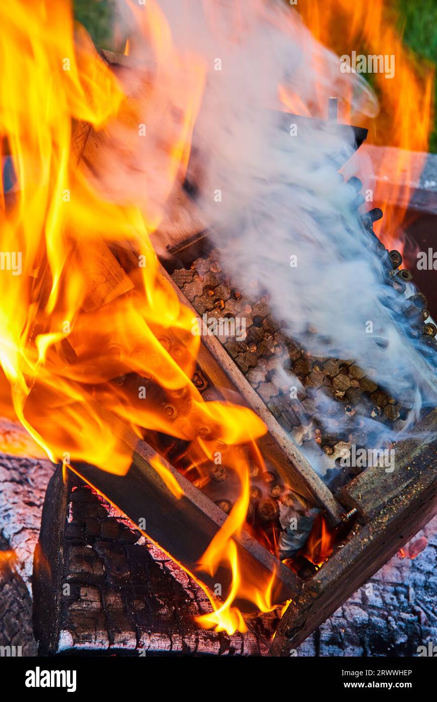 White smoke and yellow orange flames eating away at burning beehive as ...